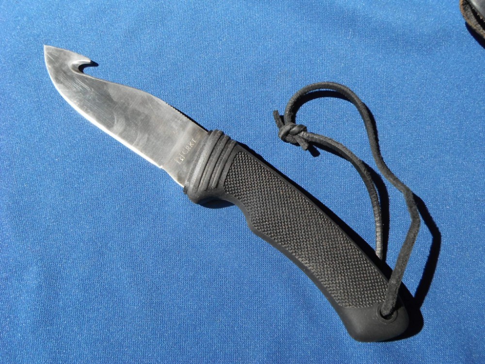 CRKT Wind River 2001 Fixed Blade Knife w/gut hook and leather sheath.