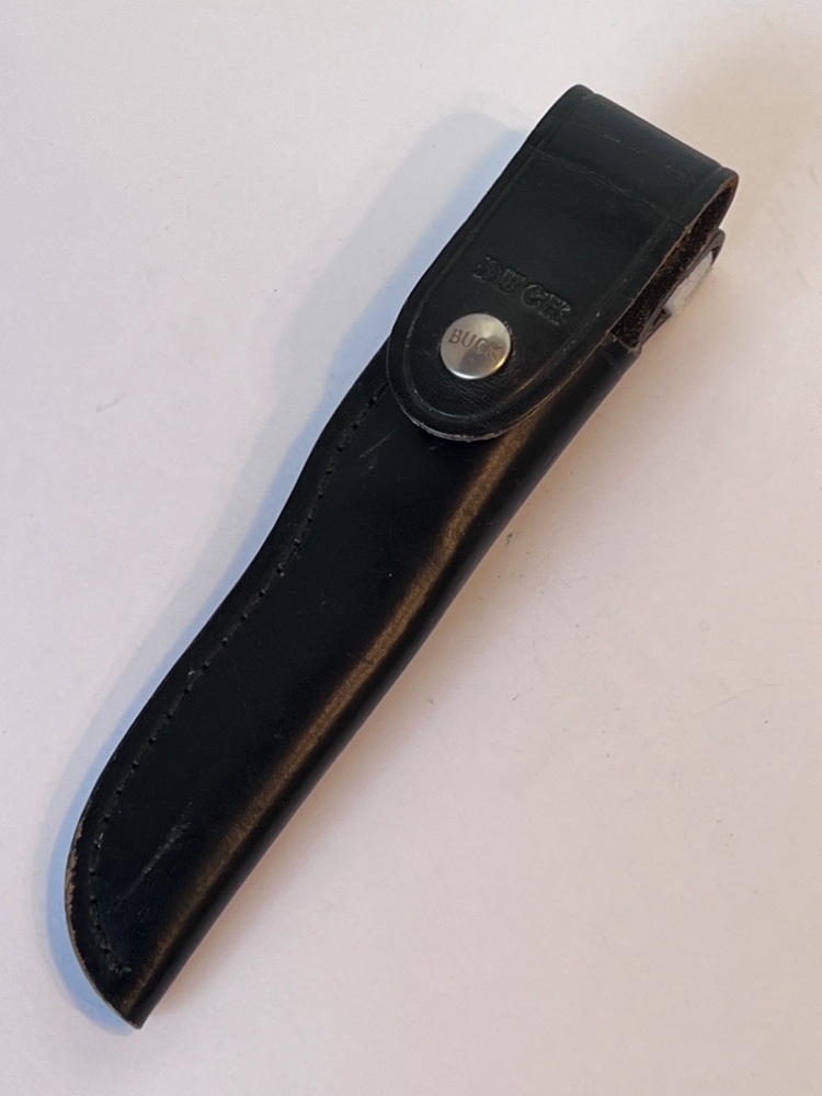 Buck 102 with Sheath. 3 Line Stamp. Light handling and use.