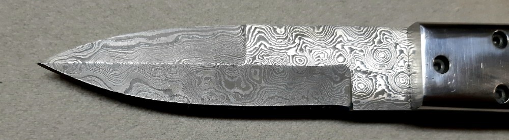 Hand made damascus switchblade with buffalo horn handles.